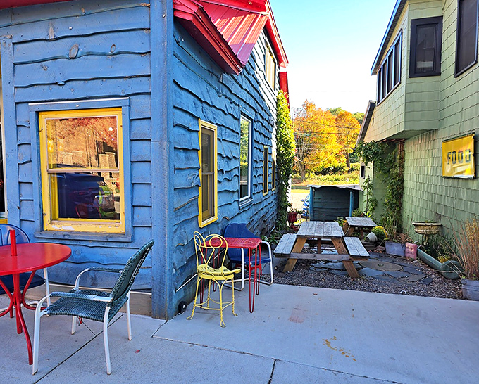 The outdoor patio offers a charming spot to enjoy your treats al fresco, with colorful chairs adding to the bakery's playful aesthetic.