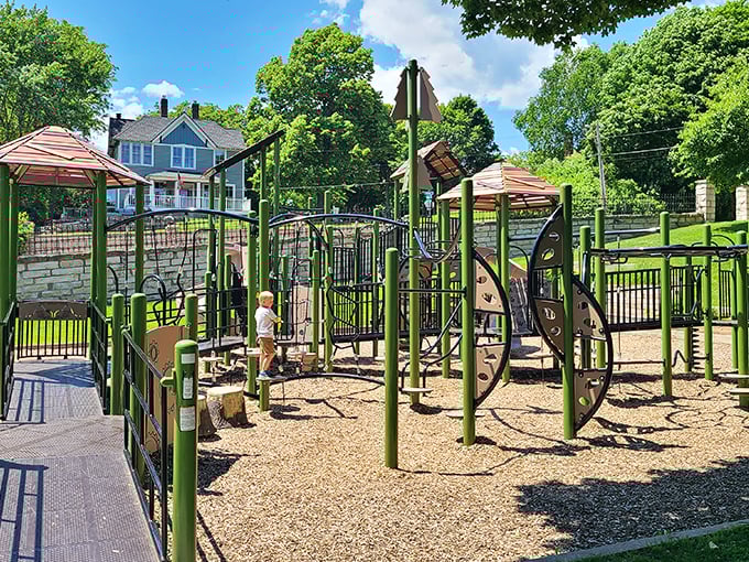 Modern playground equipment nestled among trees provides the perfect energy outlet for young explorers between downtown adventures.