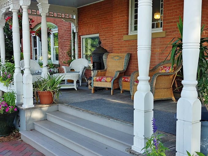 The welcoming front porch, with its classic white columns and comfortable seating, invites guests to practice the lost art of porch-sitting.