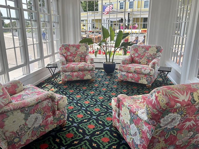 Floral-patterned armchairs create a cozy conversation nook where strangers become friends over afternoon tea and island gossip.