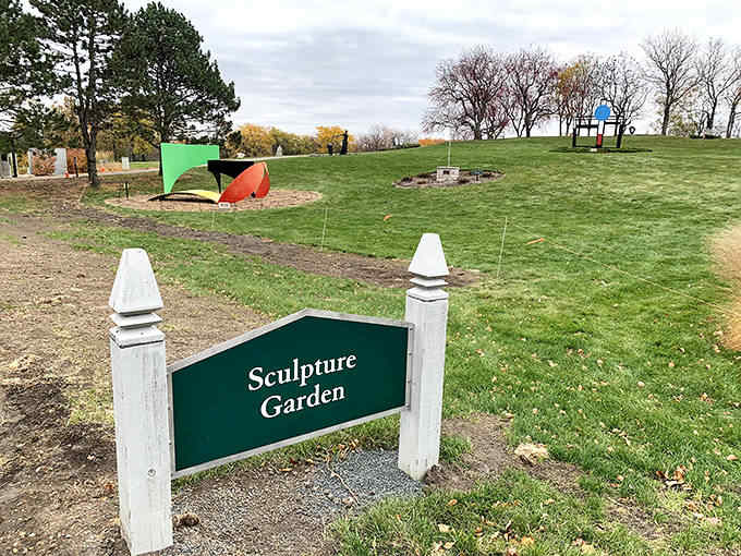 The sculpture garden sign stands guard at the entrance to a world where art and nature engage in their eternal dance of complementary beauty.
