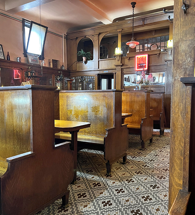 No interior designer created this authentic charm &ndash; these booths earned their patina through years of elbows, conversations, and community.