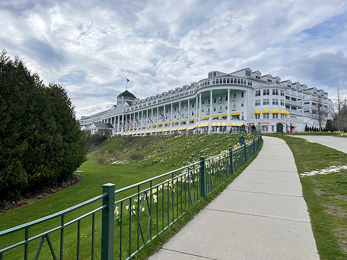 The Grand Hotel stands majestically above its gardens, the white colonial facade providing the perfect backdrop for the colorful drama below.