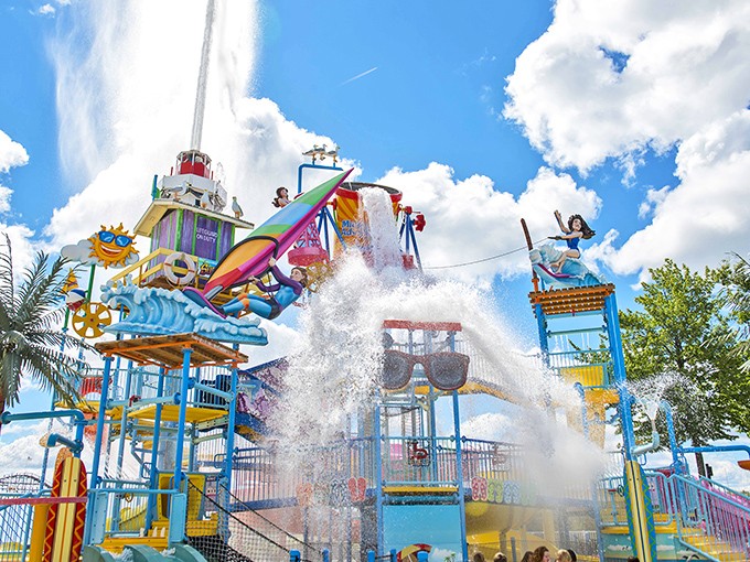 The multi-level water play structure stands like an aquatic Rube Goldberg machine, where every pipe, bucket and spray has one purpose: maximum soaking.