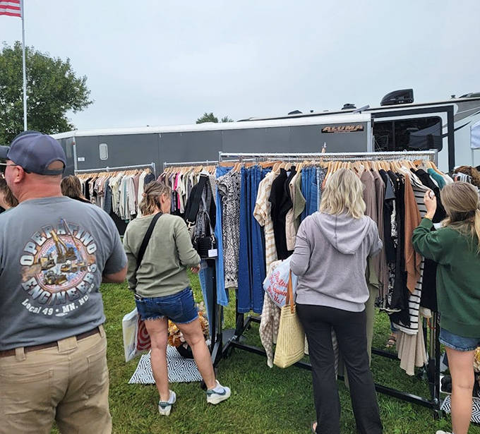 Fashion archaeology expedition: Treasure hunters rifle through clothing racks, searching for vintage gems and contemporary bargains among the carefully curated selections.