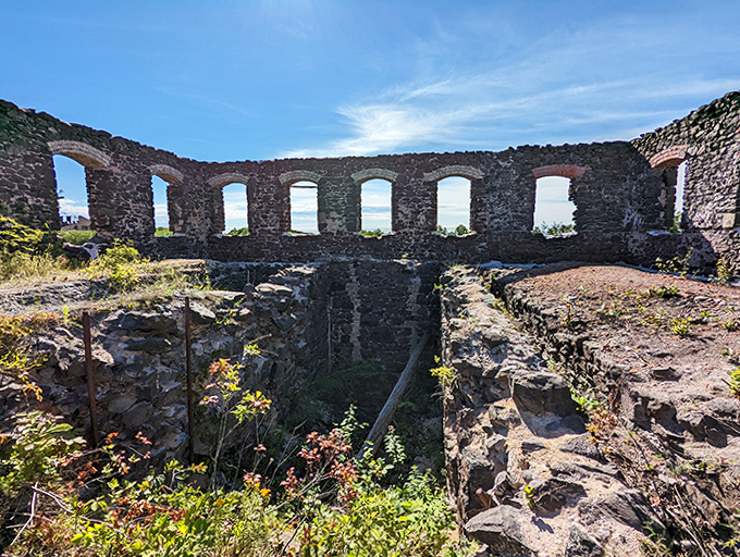 Windows to nowhere frame the Michigan sky, stone sentinels standing watch long after the miners' last shift ended.
