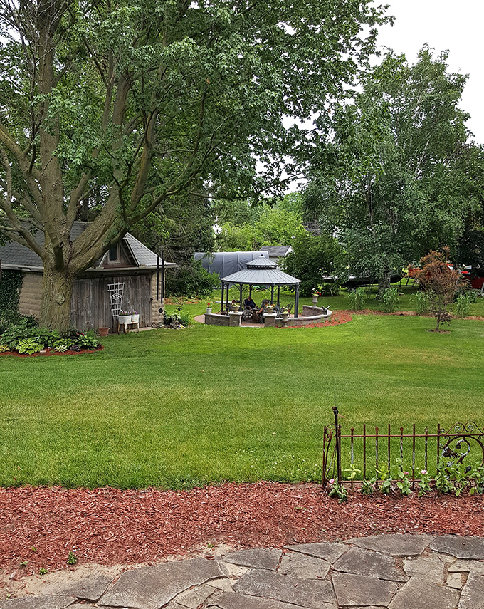 Backyard: Beyond the main house, a peaceful garden retreat awaits with shaded gazebo perfect for afternoon reading or evening wine sipping.