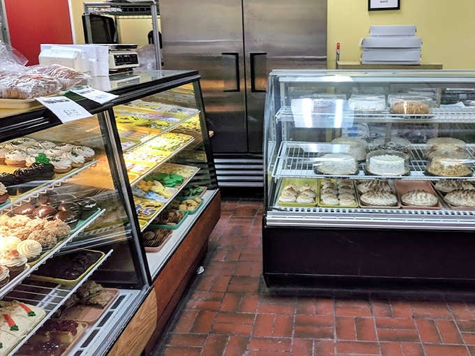 The bakery's interior reveals the serious business of sweetness, where tradition meets temptation behind spotless glass.