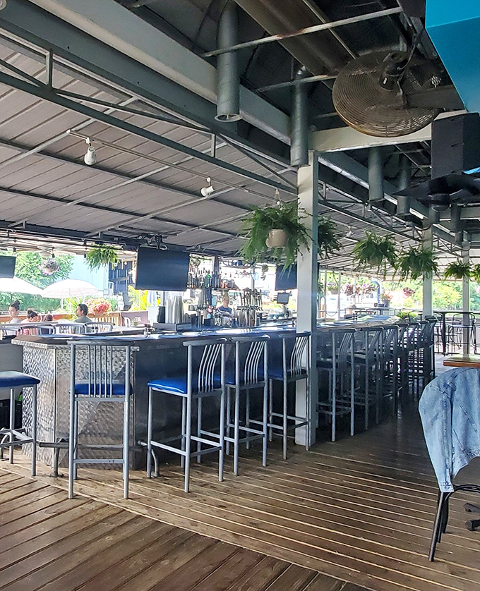 Blue cushions and metallic accents give this bar area a modern nautical vibe that perfectly complements its riverside setting.