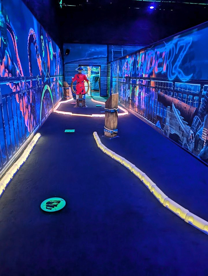 Blacklight mini-golf transforms terrible putting into a neon light show, proving everything looks cooler under ultraviolet lighting&mdash;even complete misses.