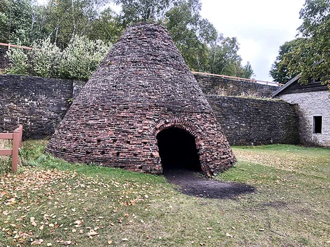 This beehive-shaped charcoal kiln once fed hungry furnaces, its brick dome a testament to the ingenuity of 19th-century industrial design.