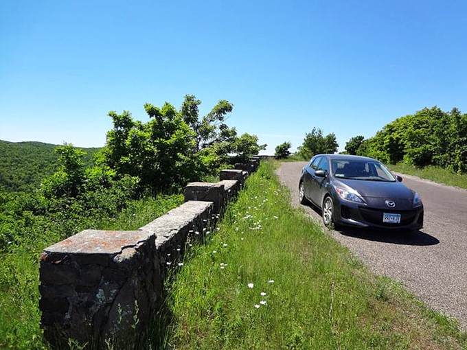 Stone guardrails, built by Depression-era workers, frame views that make modern travelers forget their own troubles.