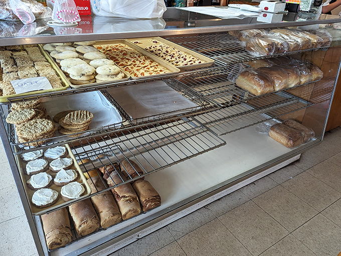 The bakery case showcases an impressive array of cookies, pastries, and breads, all made fresh and ready to make your day significantly better.