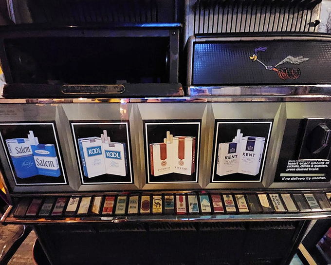 This cigarette machine hasn't dispensed smokes in years, but sometimes makes mechanical clicking sounds when nobody's near it.