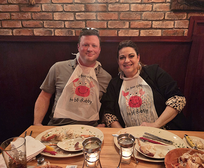 Happy diners sporting "too cute to be crabby" aprons&mdash;the universal uniform of serious seafood enthusiasts.