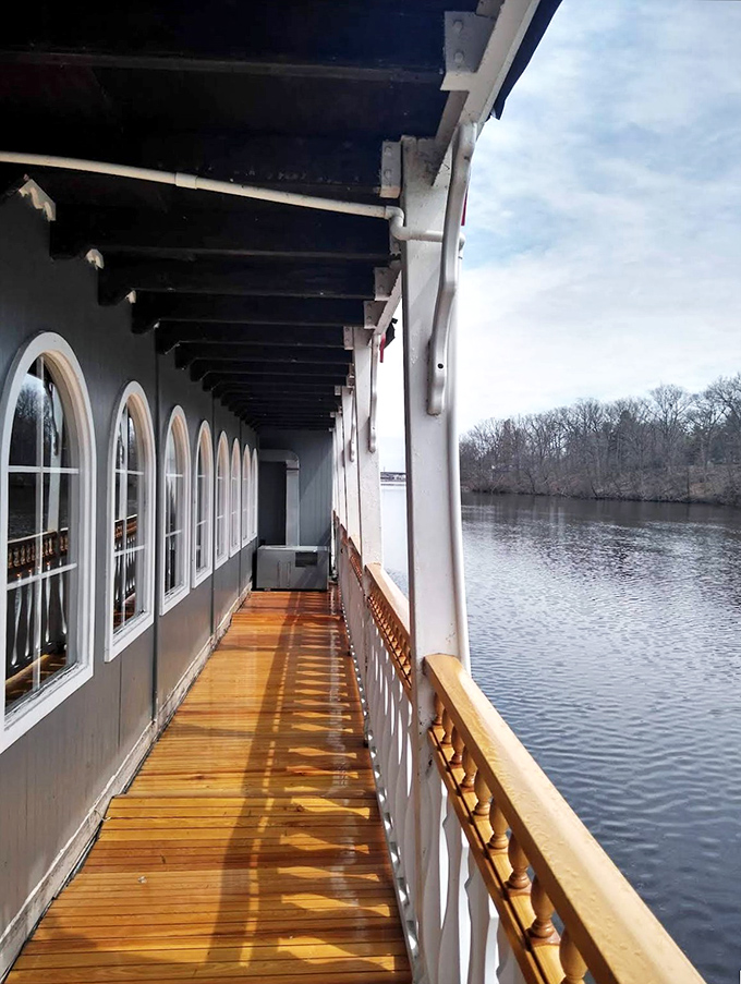 Sunlight streams across the promenade deck, creating dramatic shadows perfect for clandestine conversations and secret clue exchanges.