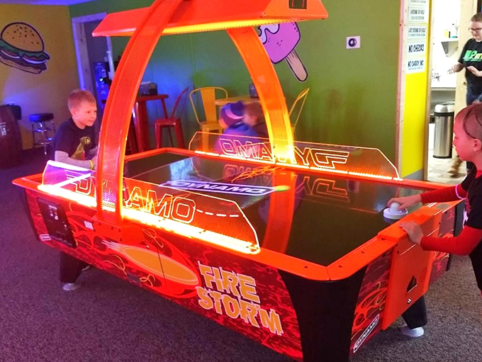 Future NHL stars face off at the air hockey table, where the puck moves faster than their parents' reflexes.