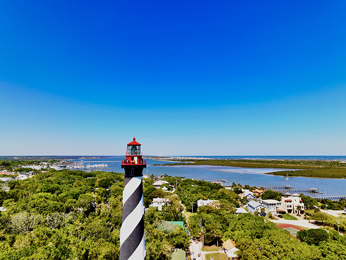 Looking up from the lighthouse base reveals the daunting climb ahead—a journey through maritime history with possibly supernatural companions.