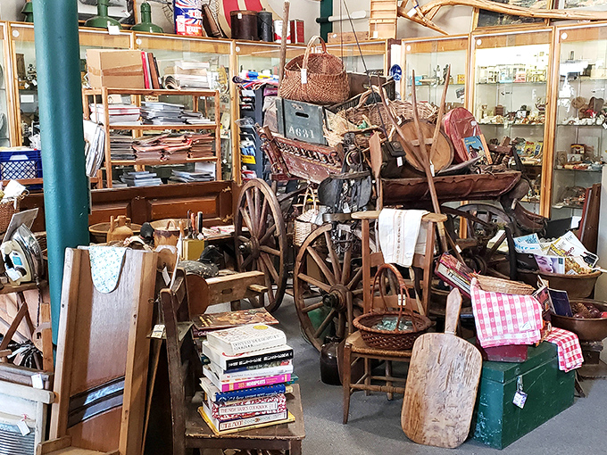 A vintage wagon overflowing with treasures creates a vignette that's part display, part time capsule, surrounded by furniture from multiple eras.