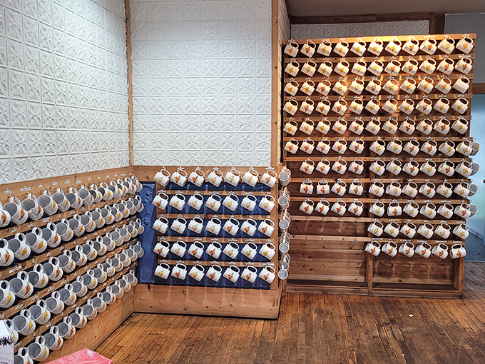 A mug collection that would make any coffee enthusiast weep with joy, displayed like the ceramic art gallery it secretly is.