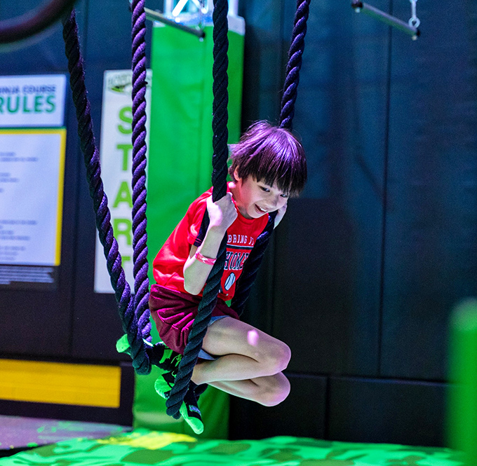 Ninja warriors in training test their upper body strength on the rope swing, channeling their inner action hero.