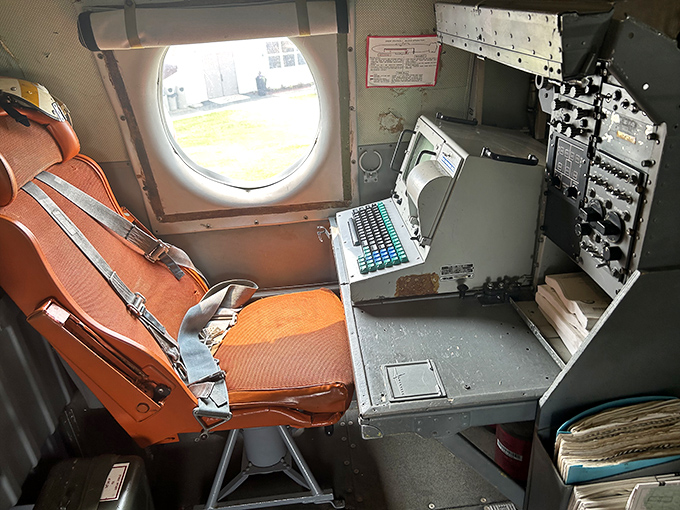 This navigator's station, with its vintage equipment and worn seat, tells silent stories of countless missions plotted over hostile territory from high above.