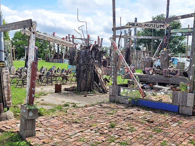 Rusted barrels create an industrial meditation garden &ndash; "Iron Teaching Rocks How to Rust" speaks to cultural relationships through materials that age and change together.