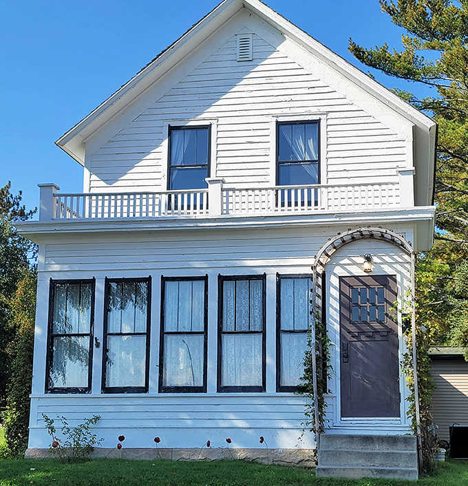The exterior view showcases classic American architecture with its welcoming front porch and windows that once framed a young girl's dreams.