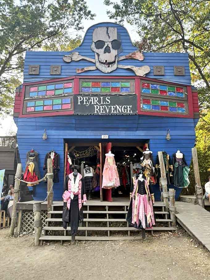 Pearl's Revenge shop offers pirate-themed costumes and accessories beneath a skull-adorned facade, perfect for visitors seeking their inner swashbuckler.