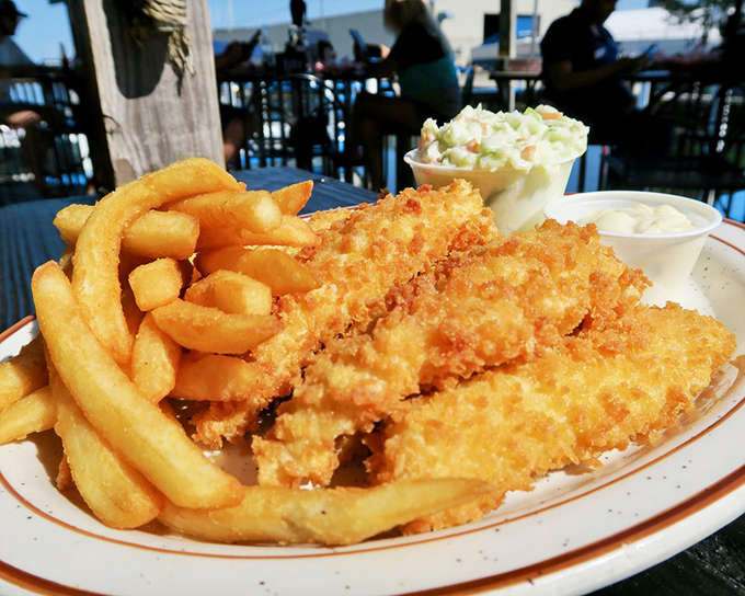 Crispy perch and golden fries served with a side of sunshine and lake views&mdash;the perfect Michigan summer on a plate.