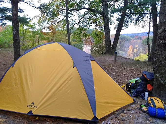 This riverside campsite offers million-dollar views that no luxury hotel can match, with stargazing and loon calls included at no extra charge.