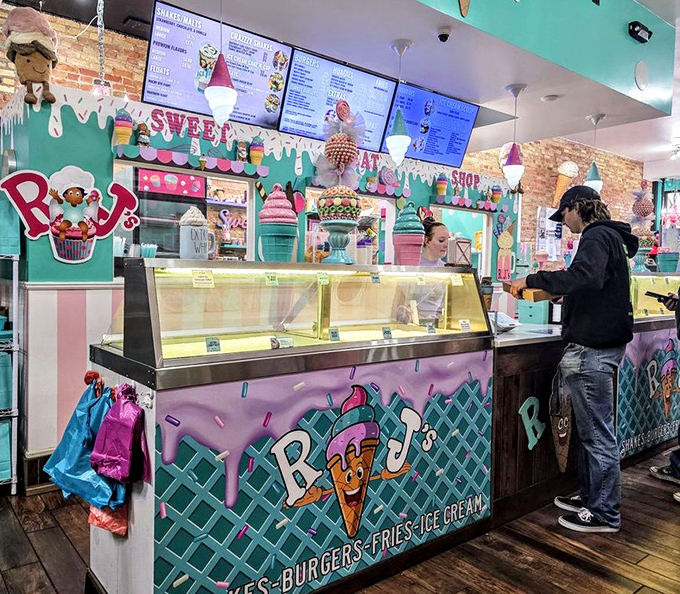 The ordering counter gleams with promise, a stage where ice cream performers create edible art while customers watch in anticipation.