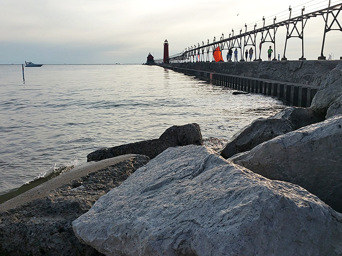 Rocky shoreline meets sandy beach where Lake Michigan's waves create a rhythmic soundtrack for afternoon contemplation.