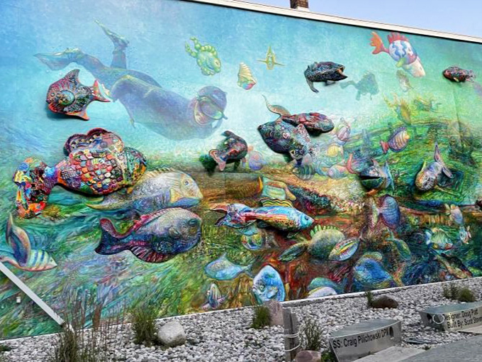 Morning light brings out different details than afternoon sun, making this a mural that rewards multiple visits throughout the changing day.