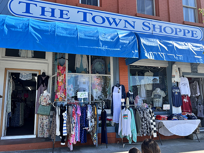 The Town Shoppe displays its colorful wares beneath a bright blue awning, tempting passersby with fashion finds that capture lakeside living.
