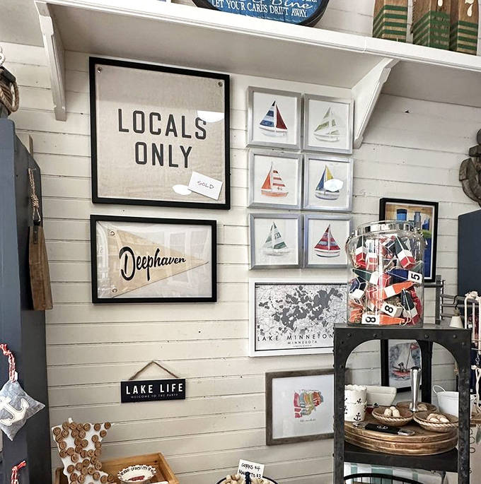 Locals Only signs and sailboat art create a gallery wall that captures the spirit of lakeside community.