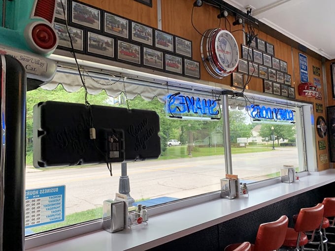 Window seats offer prime people-watching real estate while vintage license plates and car memorabilia transport you to simpler times.