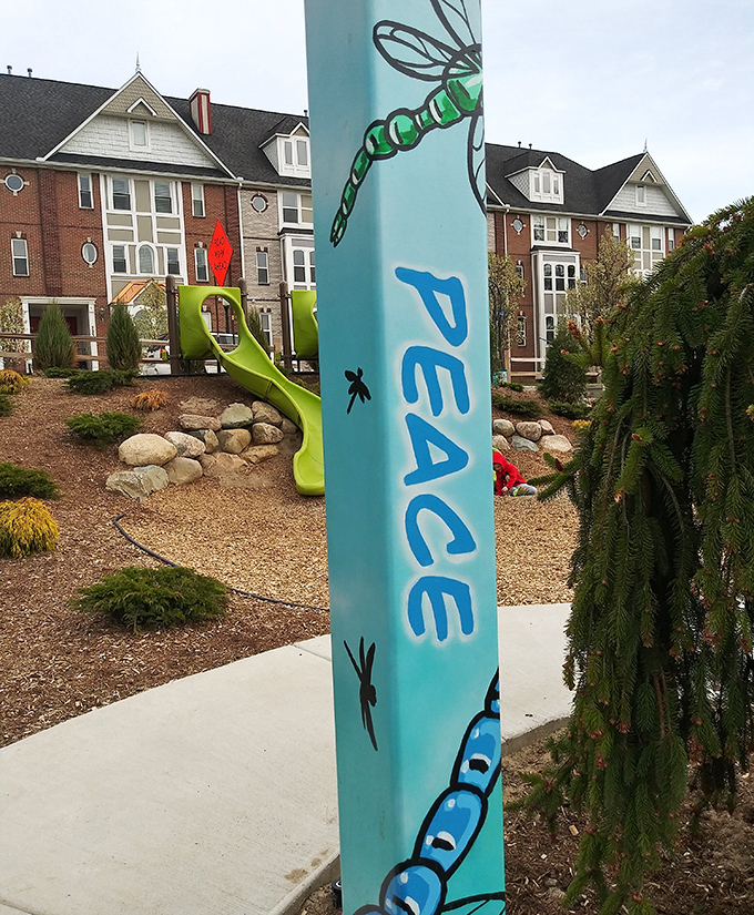 Messages of peace and hope climb skyward on painted poles, standing as colorful reminders of the community's shared values.