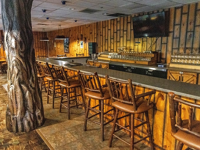 The rustic bar area provides a treehouse-like sanctuary where adults can enjoy a well-deserved beverage after surviving the water slides.