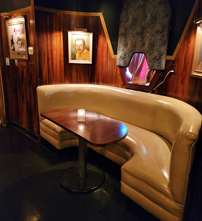 These aren't just booths – they're private kingdoms upholstered in butter-soft leather where conversations deepen as the night progresses.
