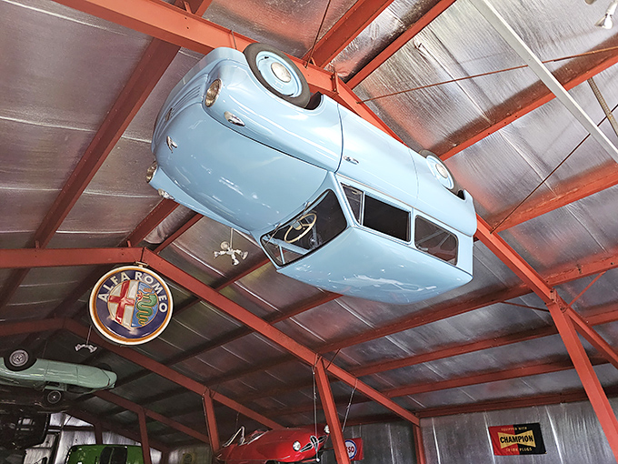Automotive innovation defying gravity, this blue microcar hangs from the ceiling like an artifact from a more whimsical era.