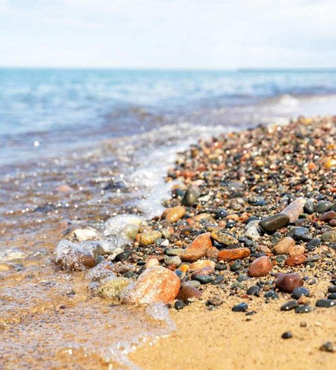 Where water meets stone: The gentle rhythm of waves continuously polishes this natural tumbler, creating tomorrow's treasures with each splash.