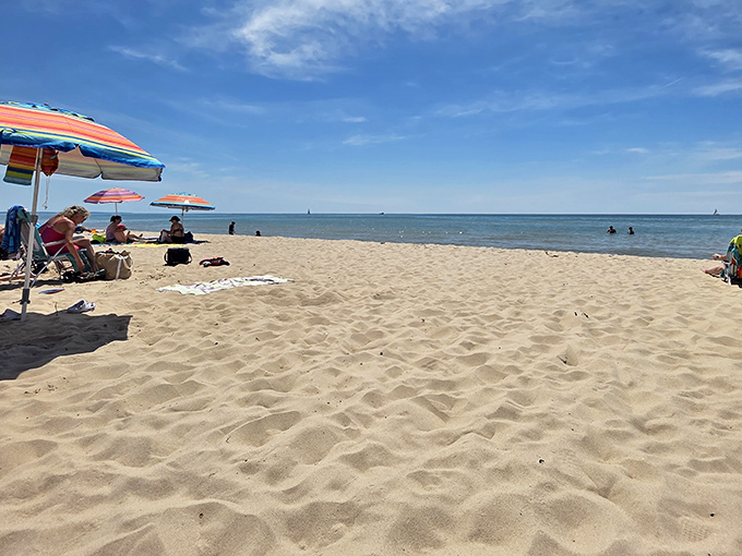 Beach umbrellas add pops of color to the shoreline &ndash; each one sheltering families making summer memories.