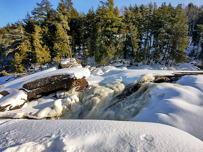 Winter's artistic touch: Snow and ice create a magical transformation, turning the falls into a partially frozen wonderland of crystalline beauty.