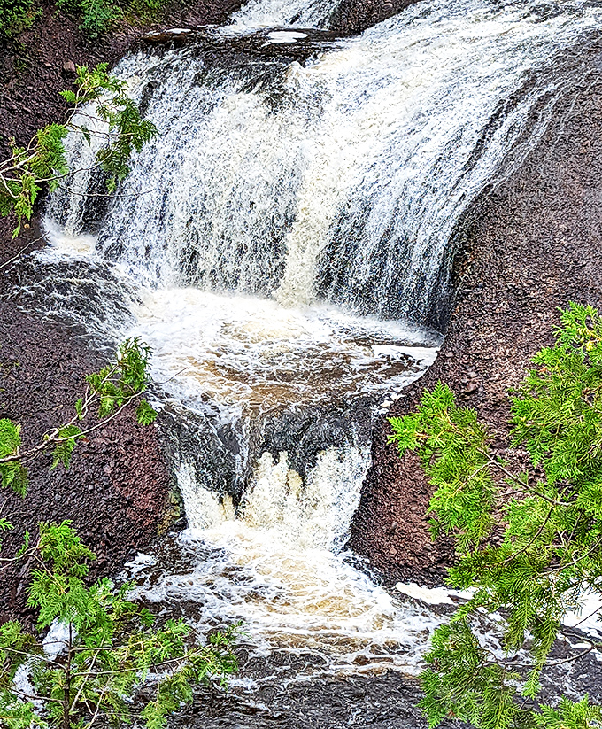 The falls create a natural staircase effect as water cascades over multiple tiers of ancient bedrock.