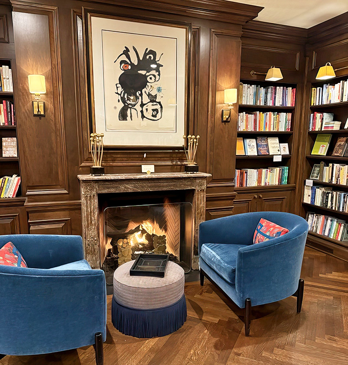 A crackling fire and plush seating create the coziest reading nook this side of a Victorian novel.