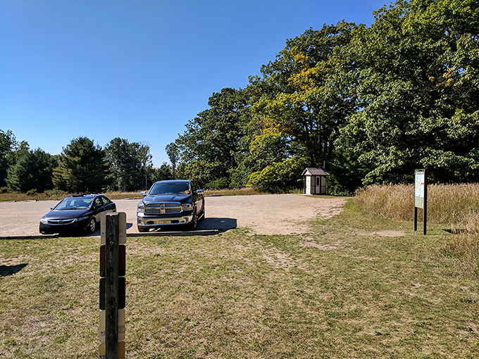 The humble parking area where adventures begin &ndash; no valet service, just the promise of something authentic waiting beyond the trees.