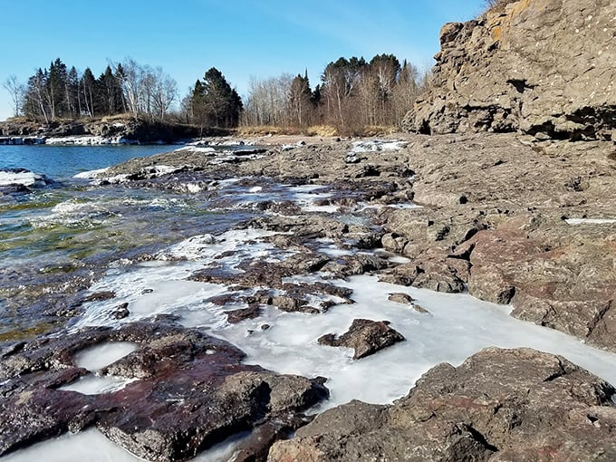 Winter's artistic touch: Ice formations transform the shoreline into nature's sculpture garden during Minnesota's dramatic cold season.
