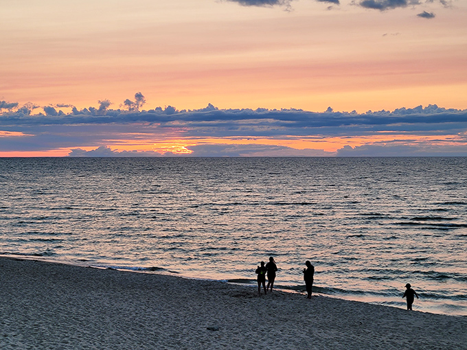 Beach therapy in session! As day visitors soak in Lake Huron's sunset spectacle, worries seem to dissolve into the colorful horizon.