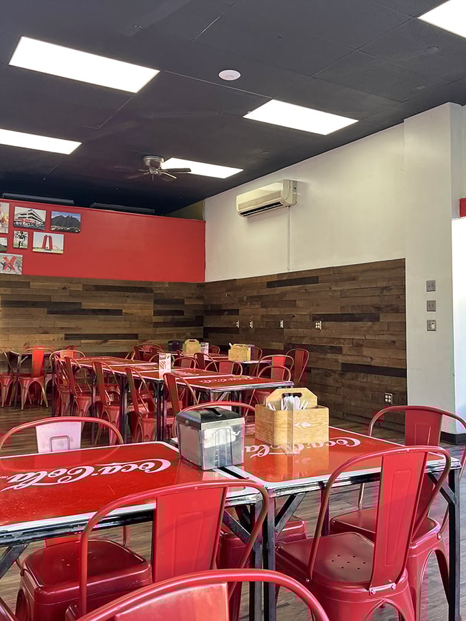 The dining area's warm wood paneling and bright red chairs create a welcoming space where strangers become friends over shared meals.